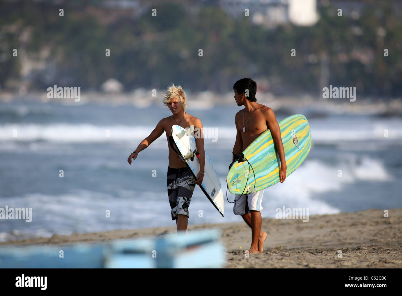Surfers walking along famous Zicatela beach in Puerto Escondido, Mexico ...