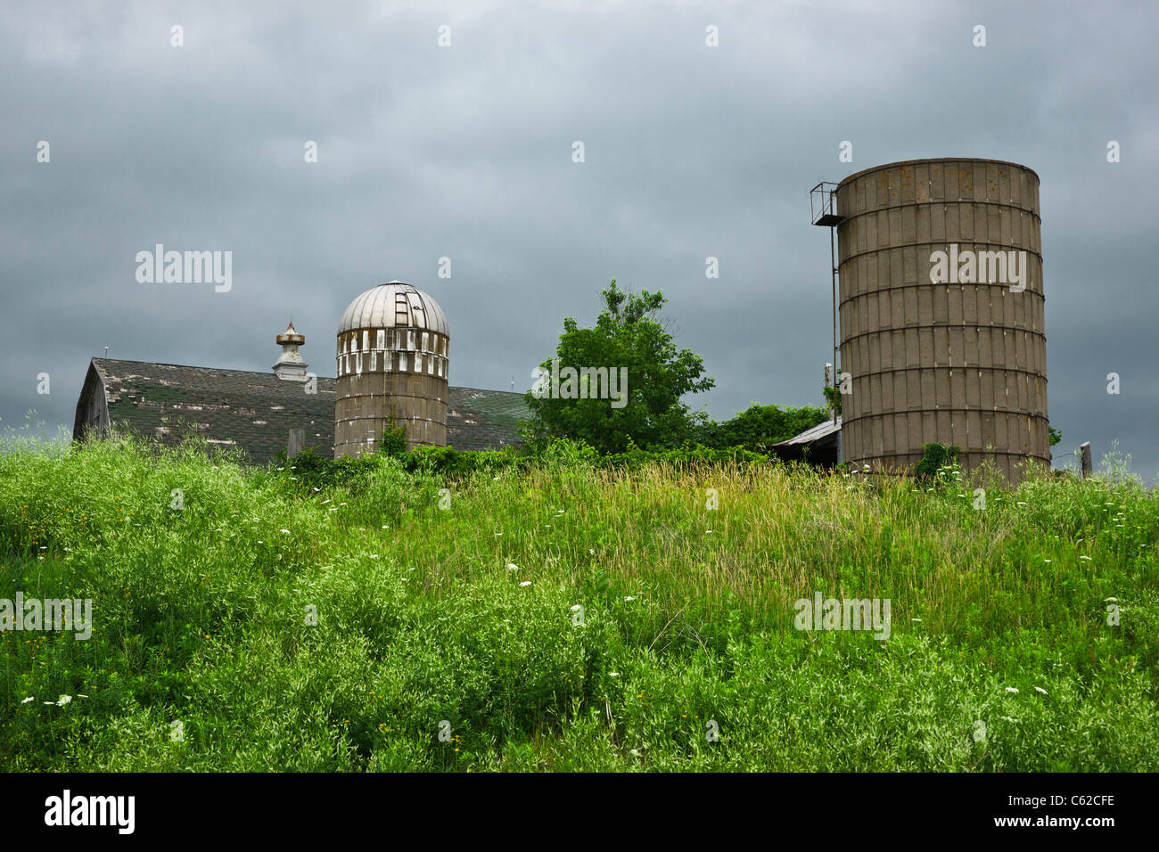 Rural scenery from Minnesota. Old farm building, barn and silo against ...