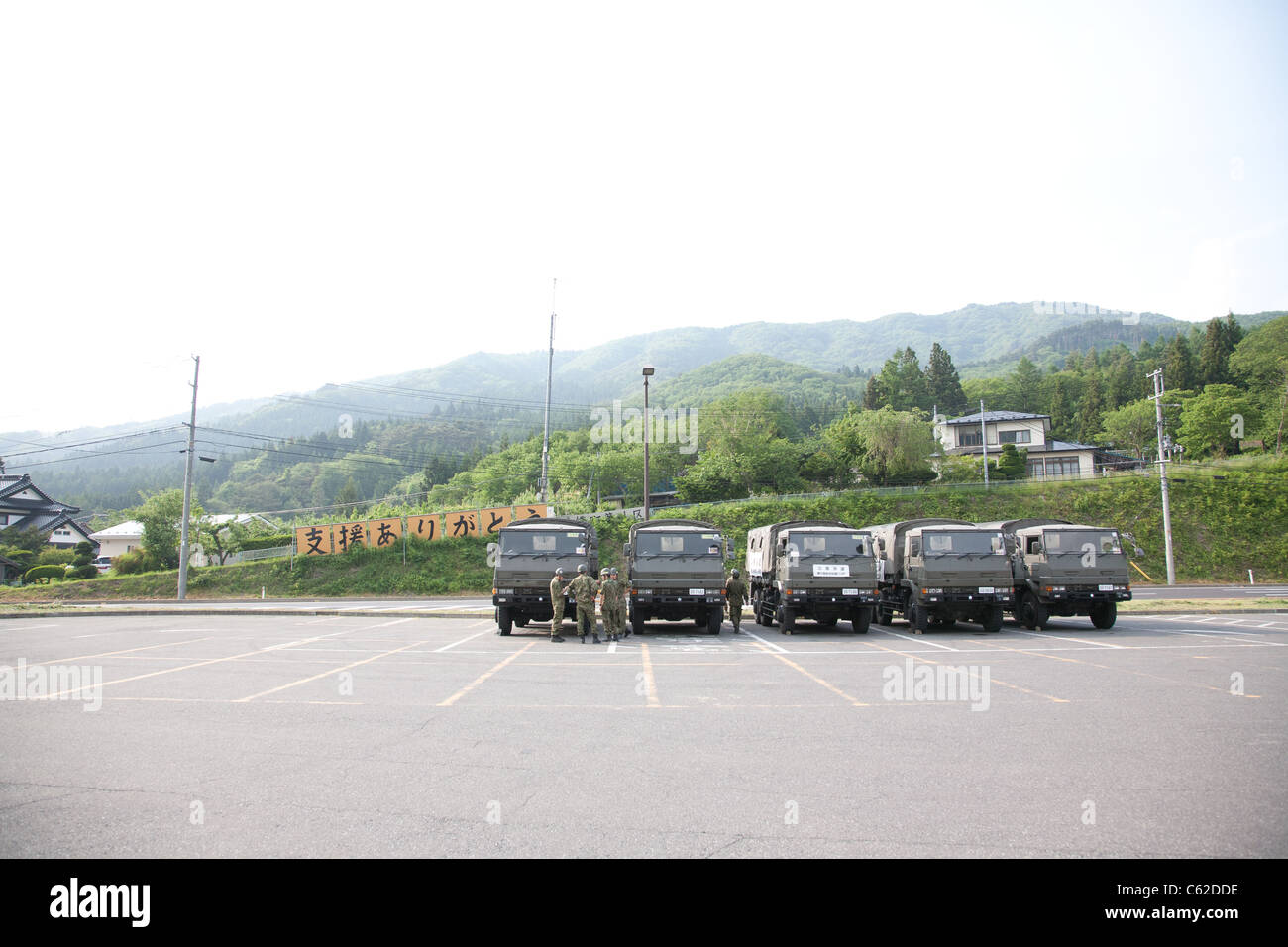 Japanese military vehicles are parked at a rest stop between Hanamaki ...
