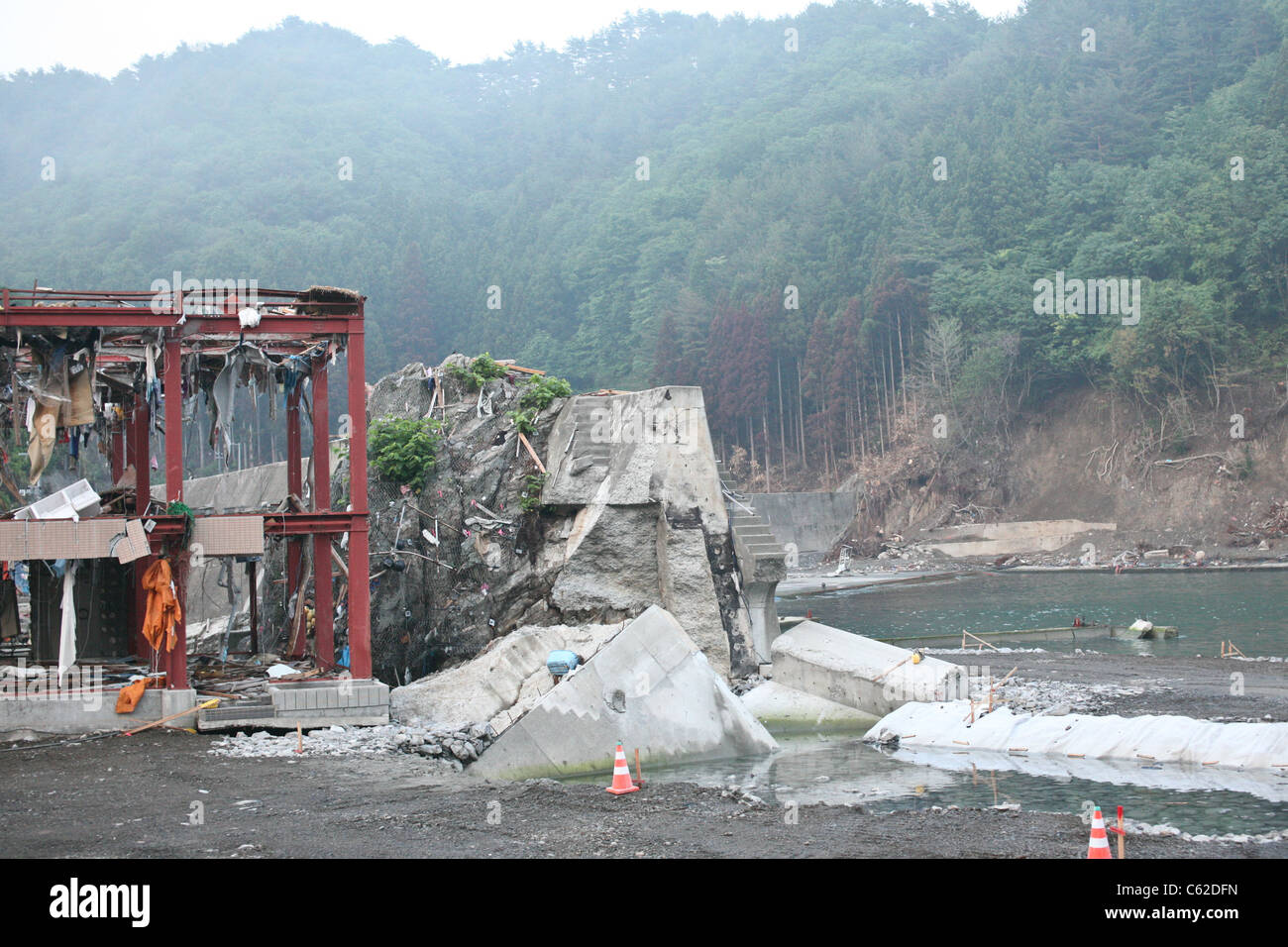 A tsunami wall failed near Kesennuma, Japan and the buildings and ...