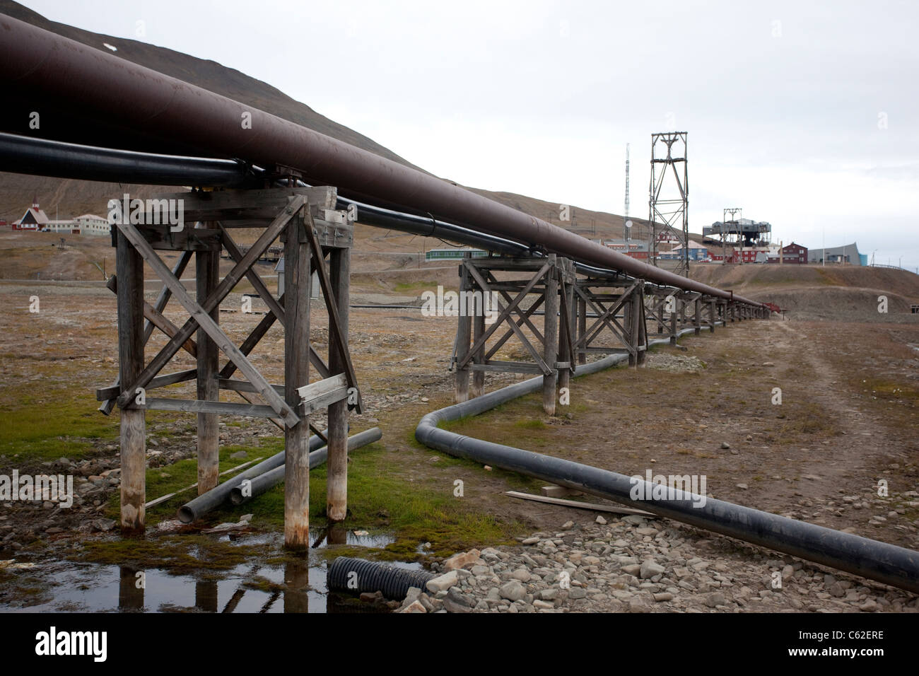 Utility pipes on raised covered platforms running above the ground at ...