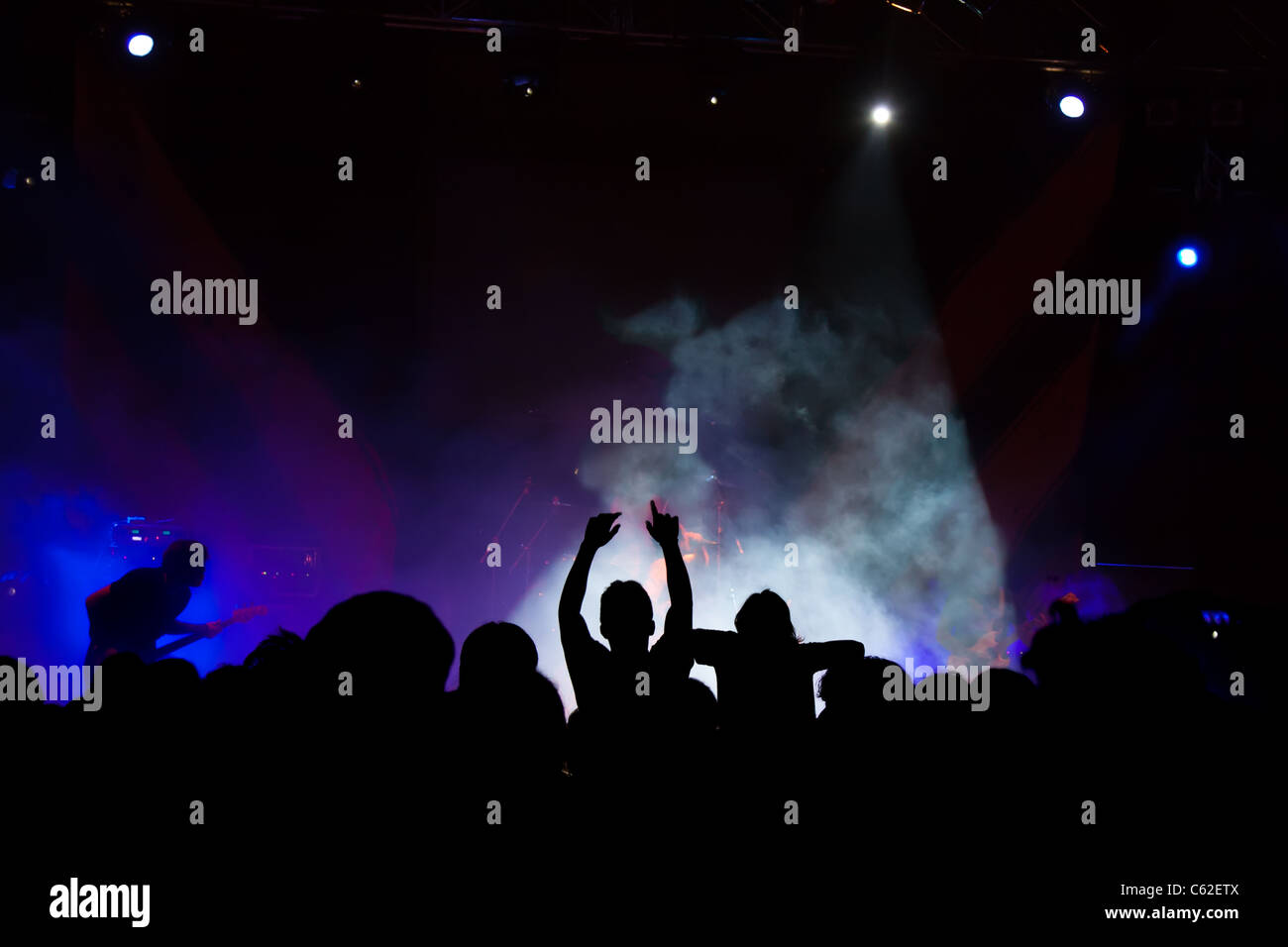 Live and powerful concert. Dark shot aiming the stage and the ...