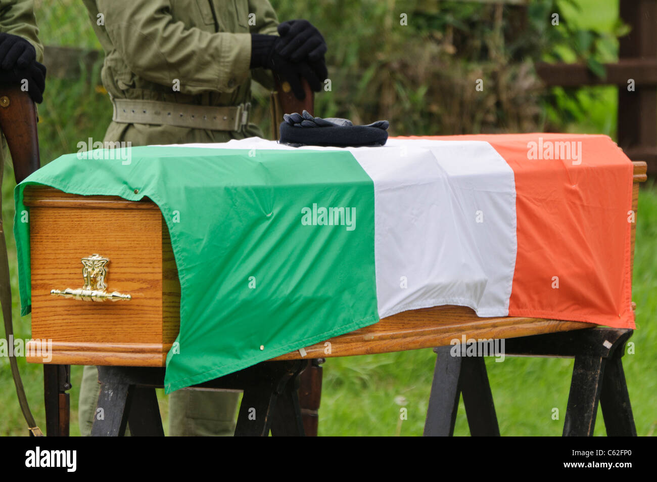 IRA paramilitary gloves and beret on a coffin with an Irish Tricolour ...