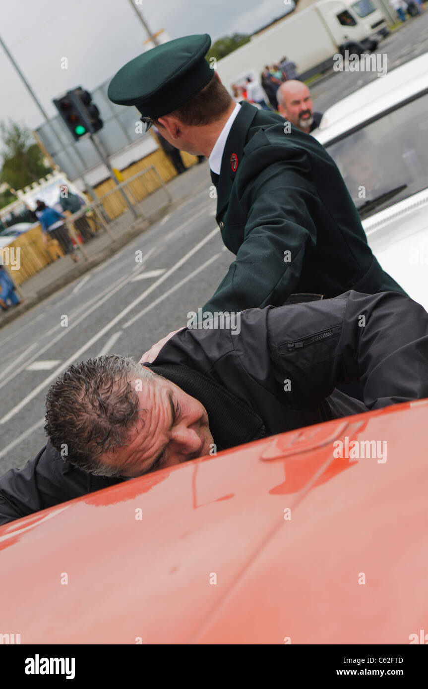 Men dressed in RUC and Army uniforms reenact a stop and search in ...