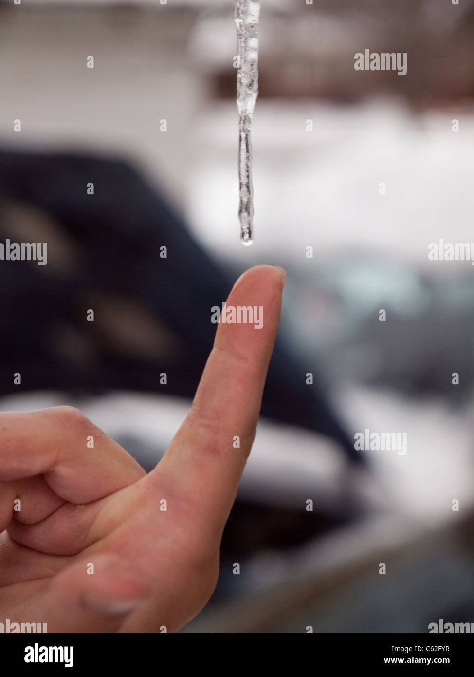Finger touching ice Stock Photo - Alamy