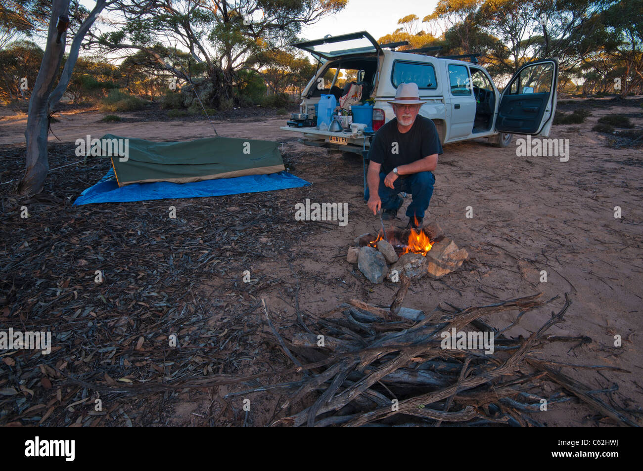 Man with campfire and pitched swag in the Australian outback Stock ...