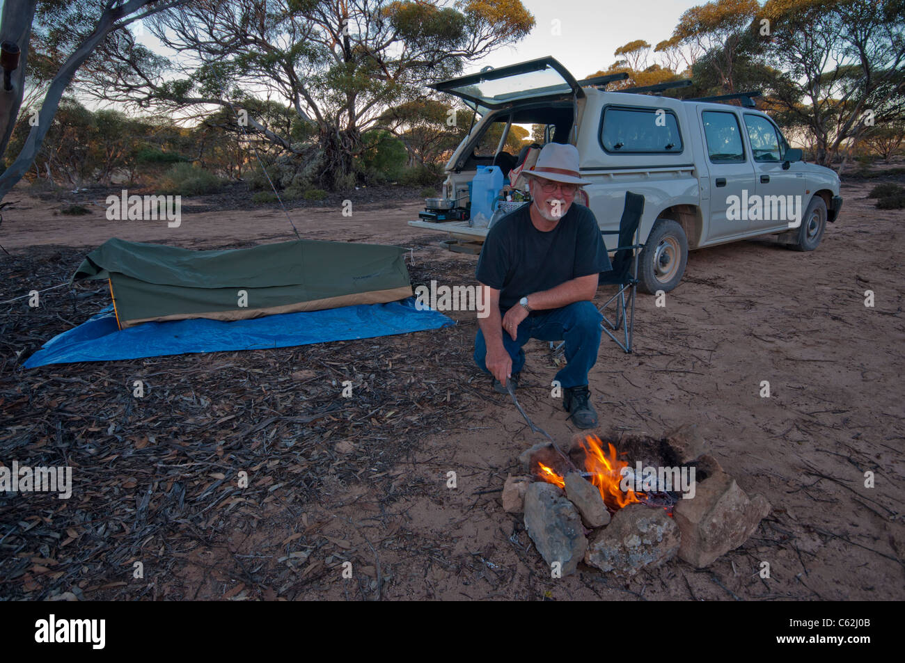 Man with campfire and pitched swag in the Australian outback Stock ...