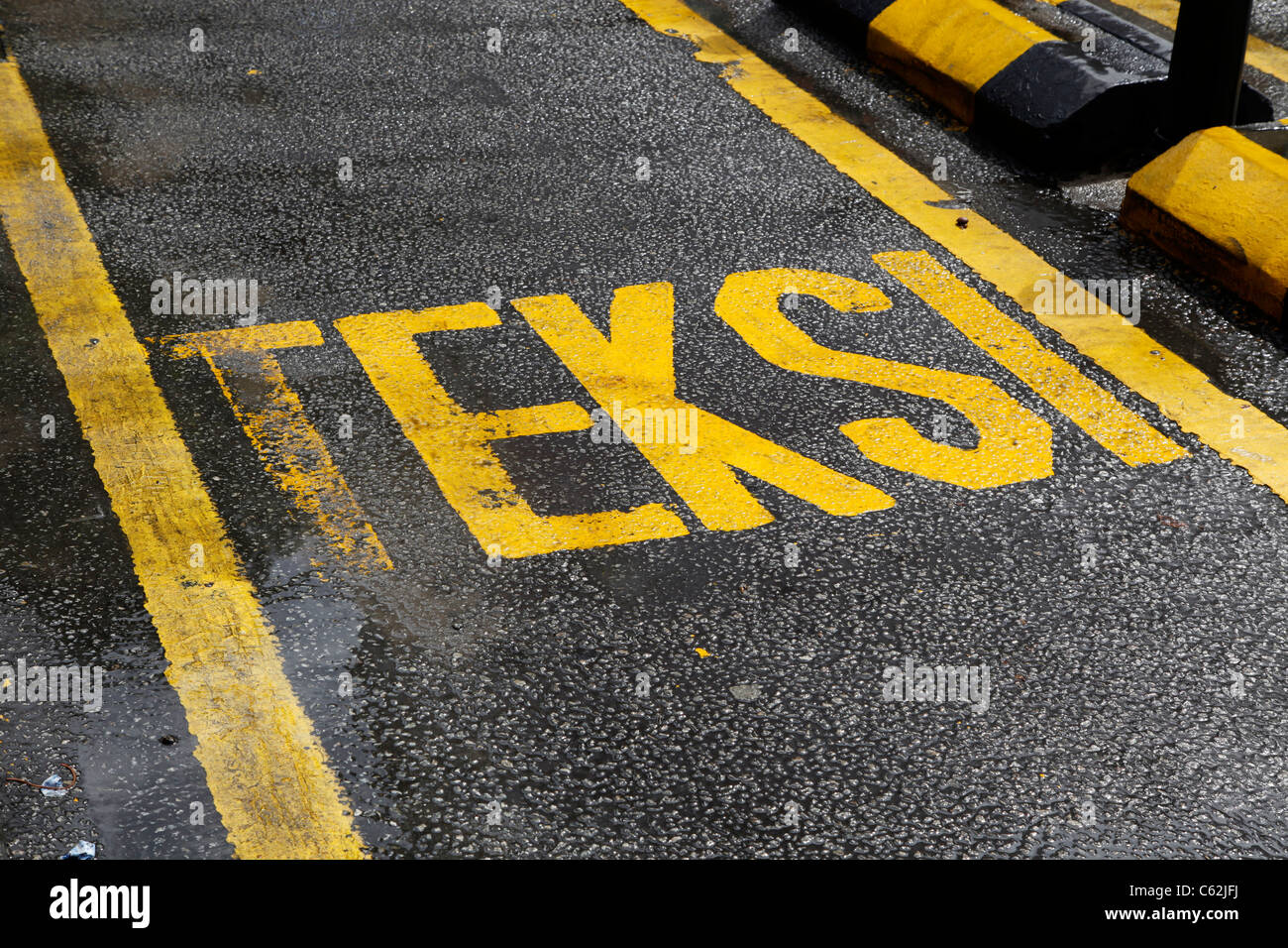 Teksi written on the road of a taxi cab rank in Kuala Lumpur, Malaysia ...