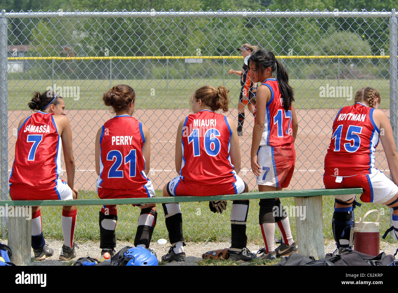 High School girls sitting on the bench during a time out at a Softball ...