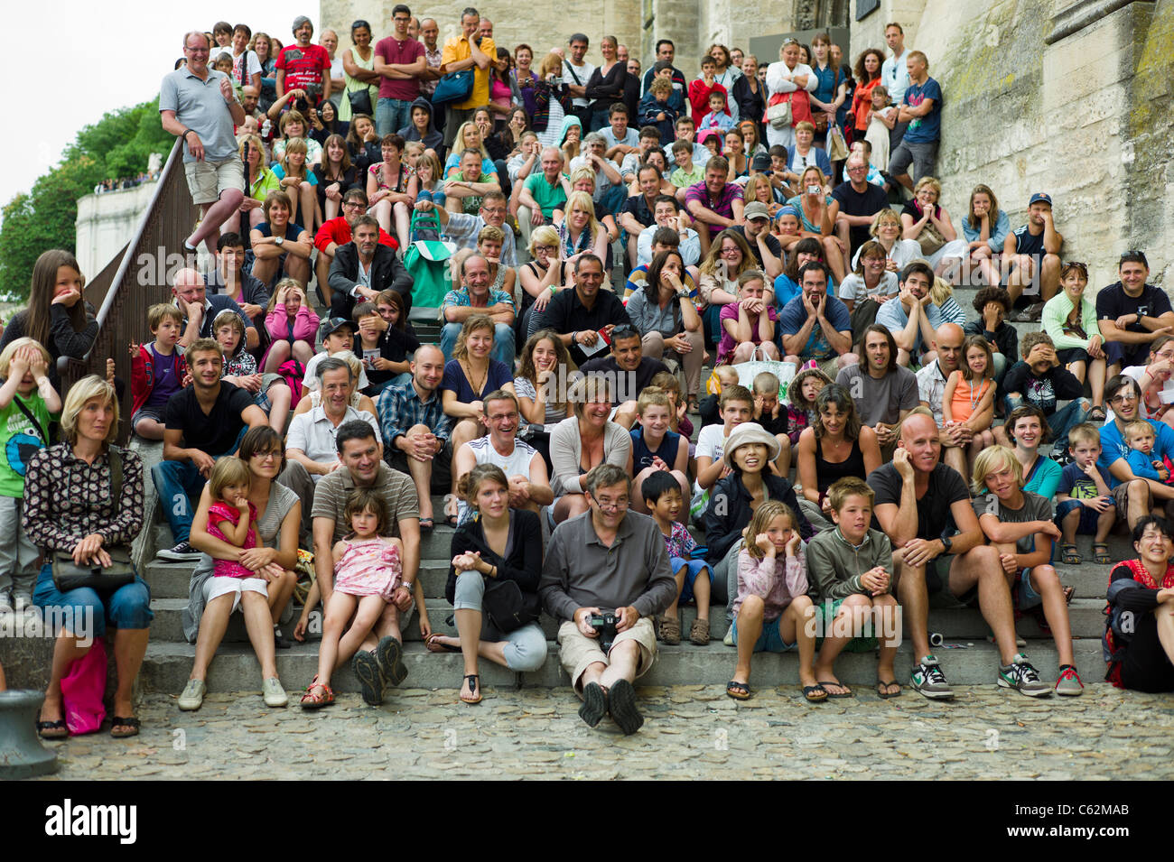 People being entertained by a street performer on the steps of Palais ...