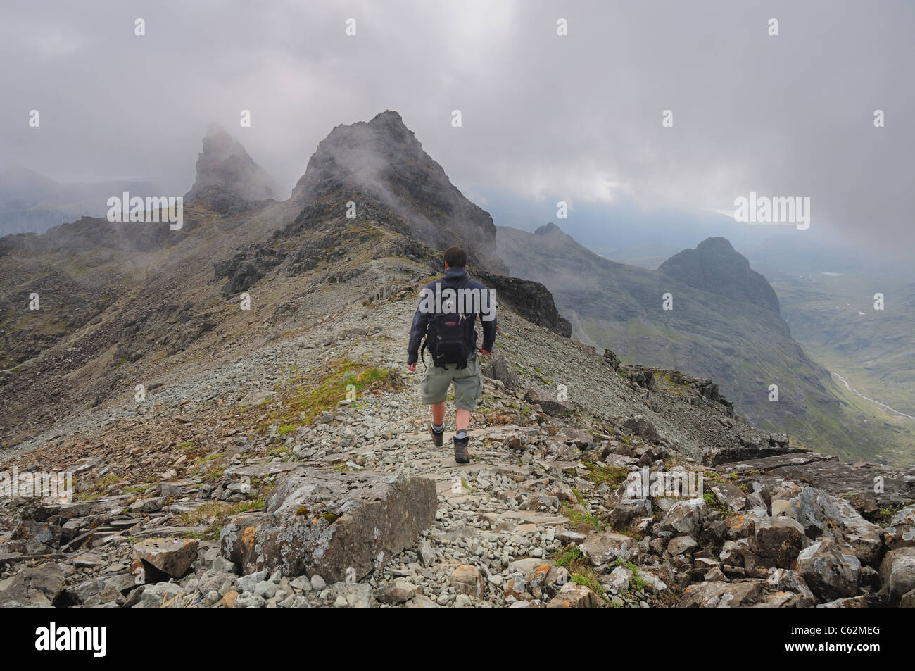 Walker on misty Bruach na Frithe looking towards Sgurr a Fionn Choire ...