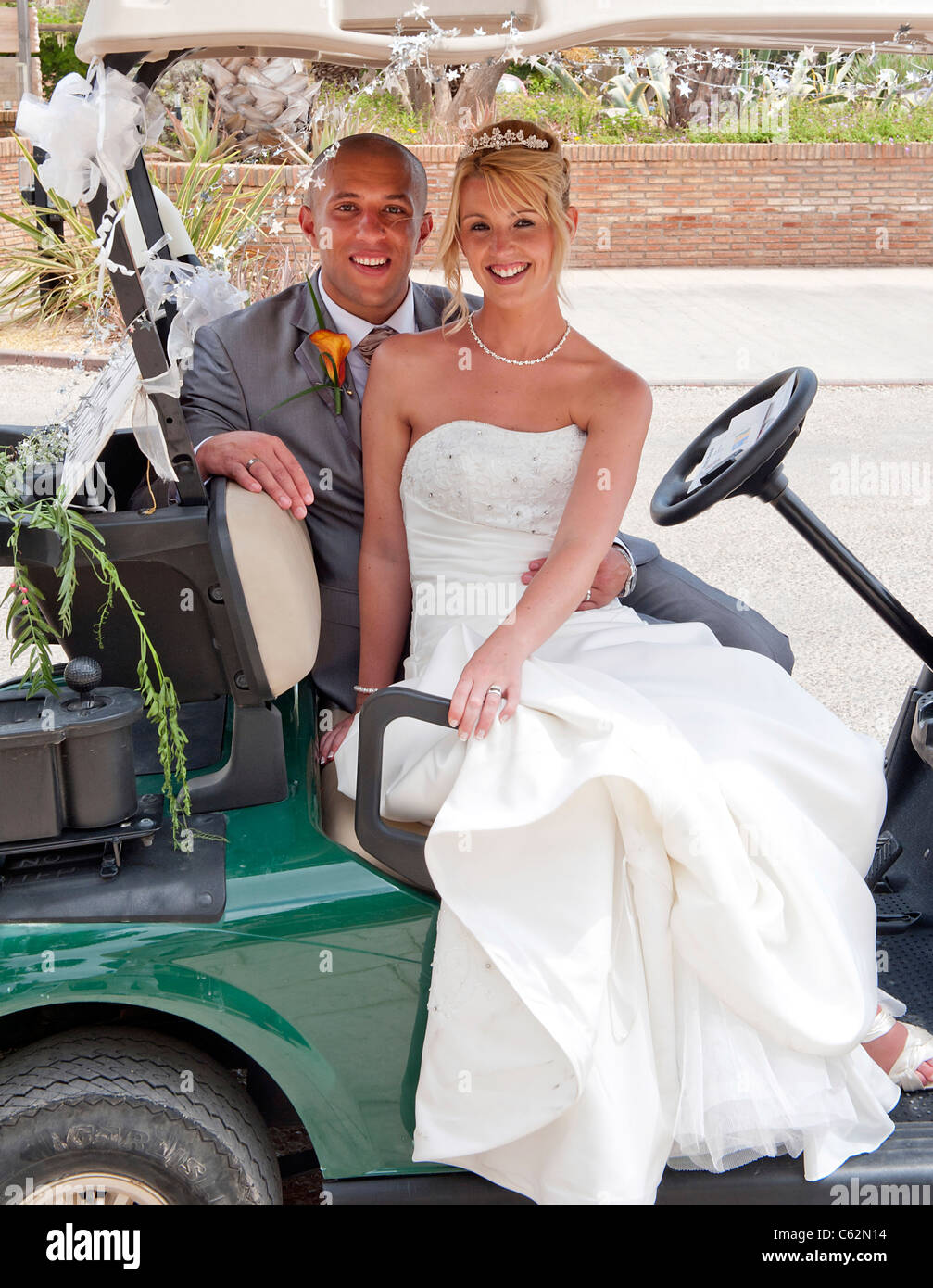 Bride and Groom in a golf cart at the reception Stock Photo - Alamy