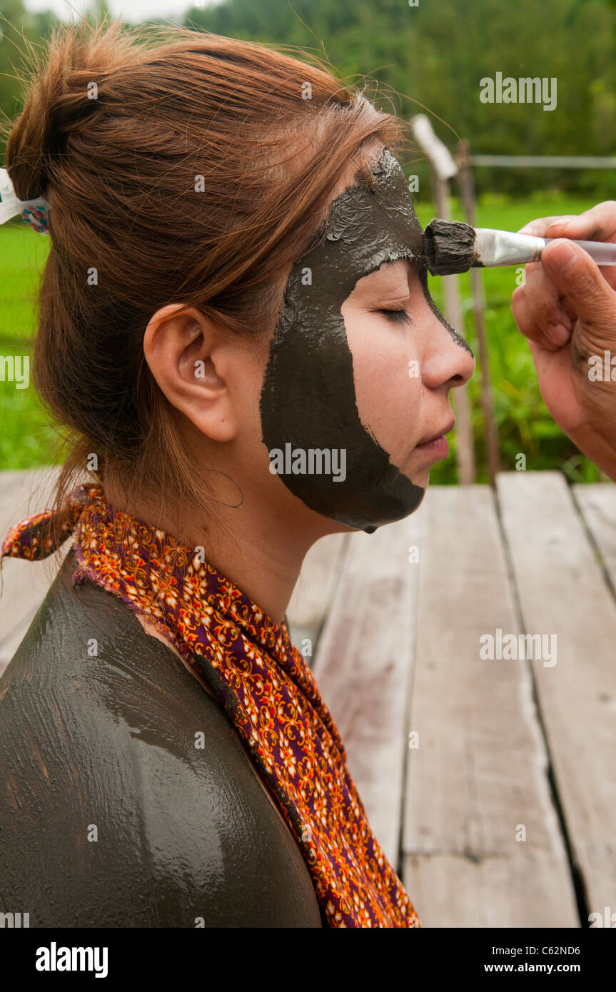 Thai woman enjoying a therapeutic mud treatment at the Phu Klon Mud Spa ...