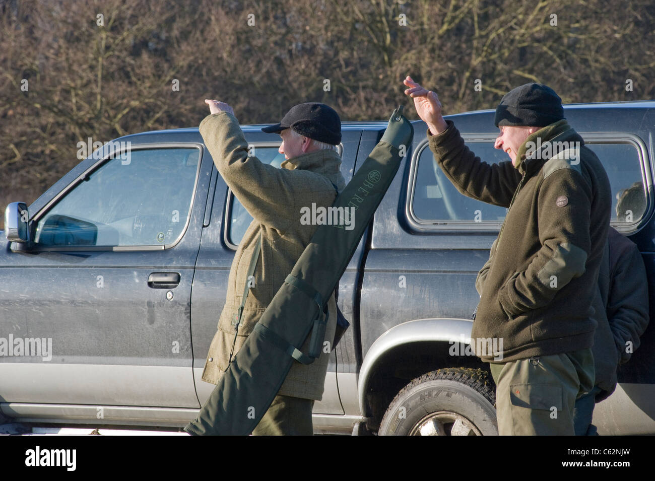 men shielding eyes against sun Stock Photo - Alamy