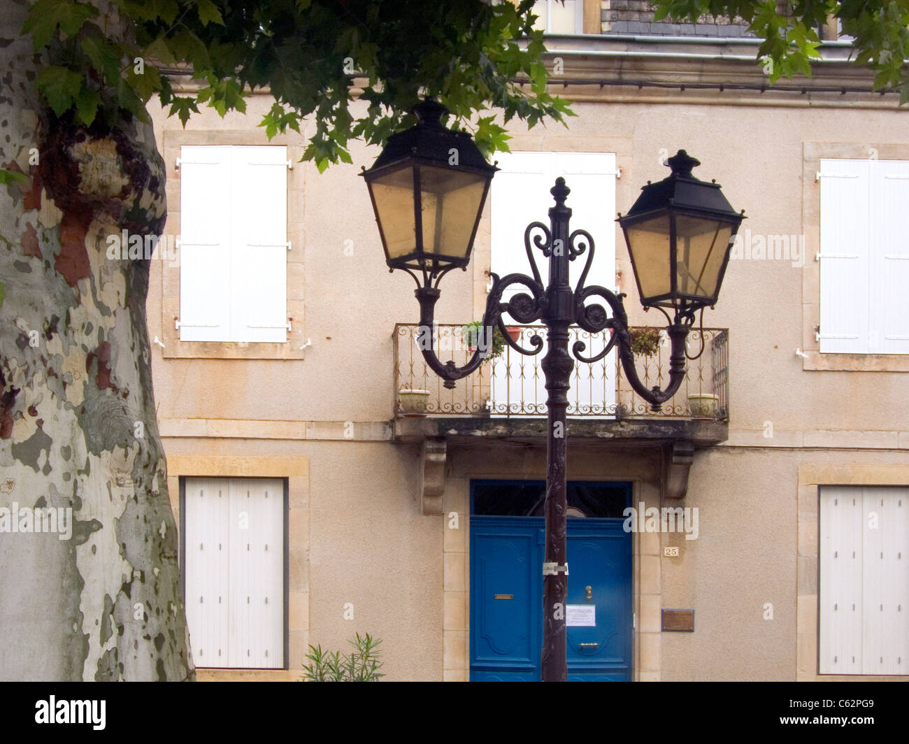 Typical french street lights and shuttered houses around the market ...