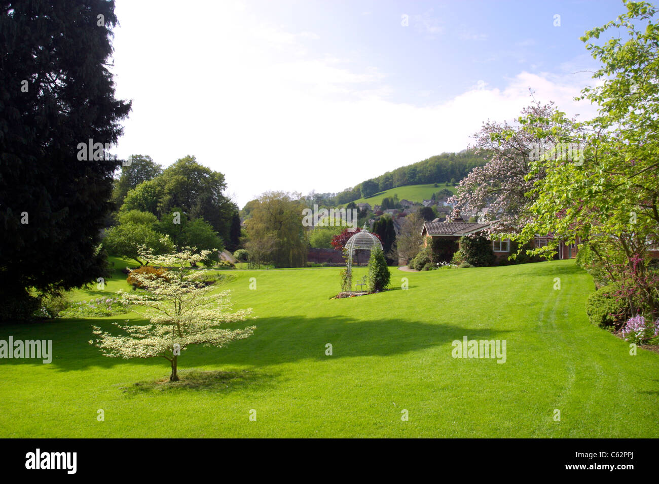 Large manicured lawned UK garden with trees, shrubs and features Stock ...