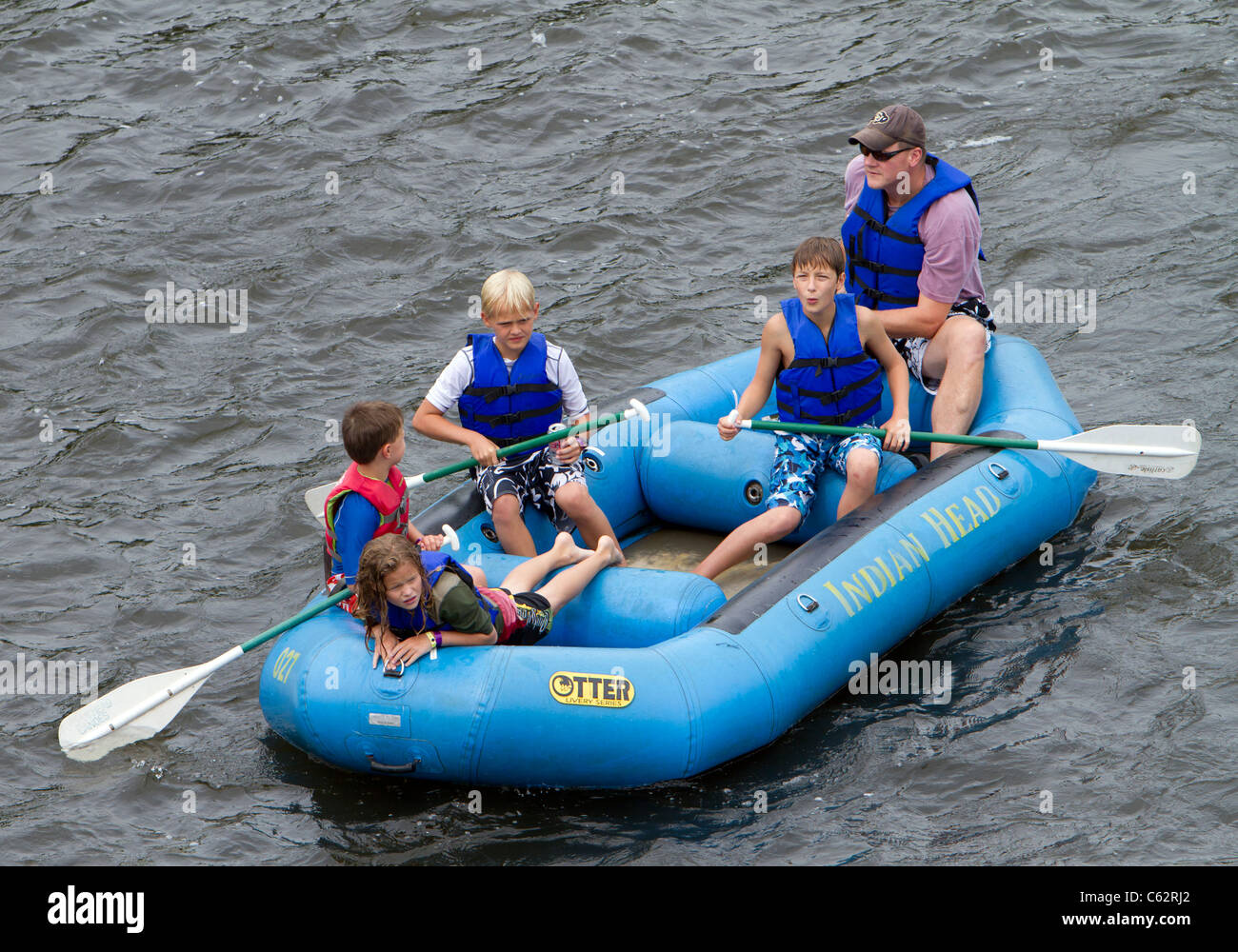 Father with children river rafting Stock Photo - Alamy