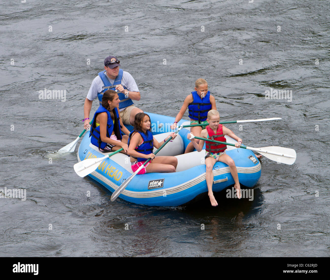 Father and four daughters floating down the river. River rafting Stock ...