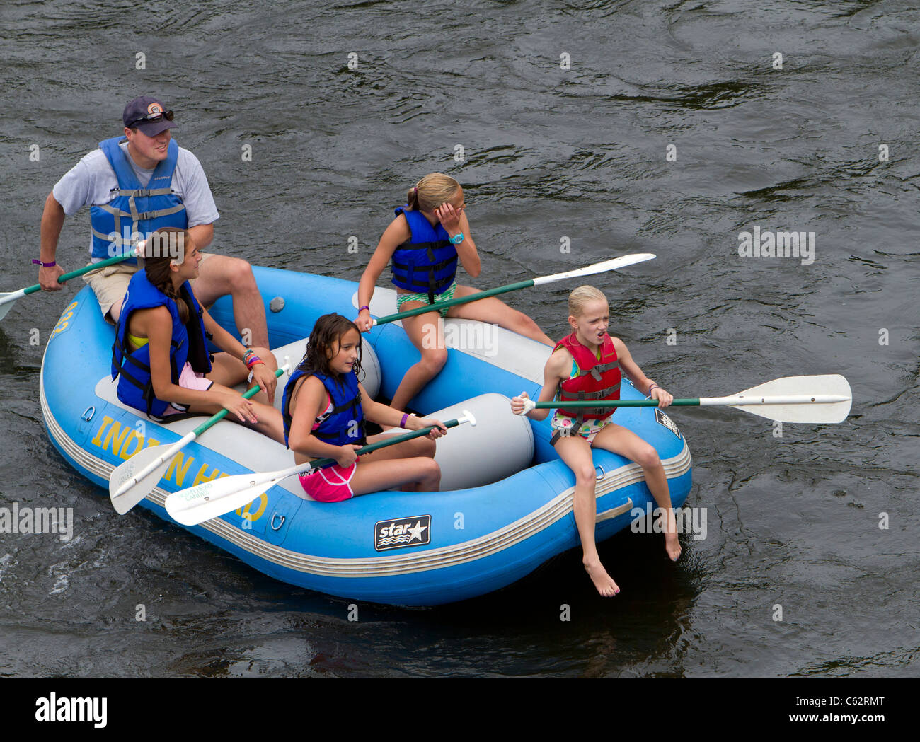 Father and four daughters floating down the river. River rafting Stock ...