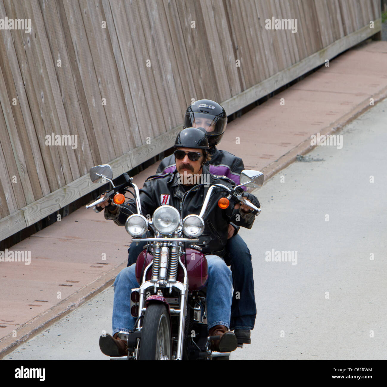 rider and passenger on a motorbike motorcycle wearing helmets Stock ...