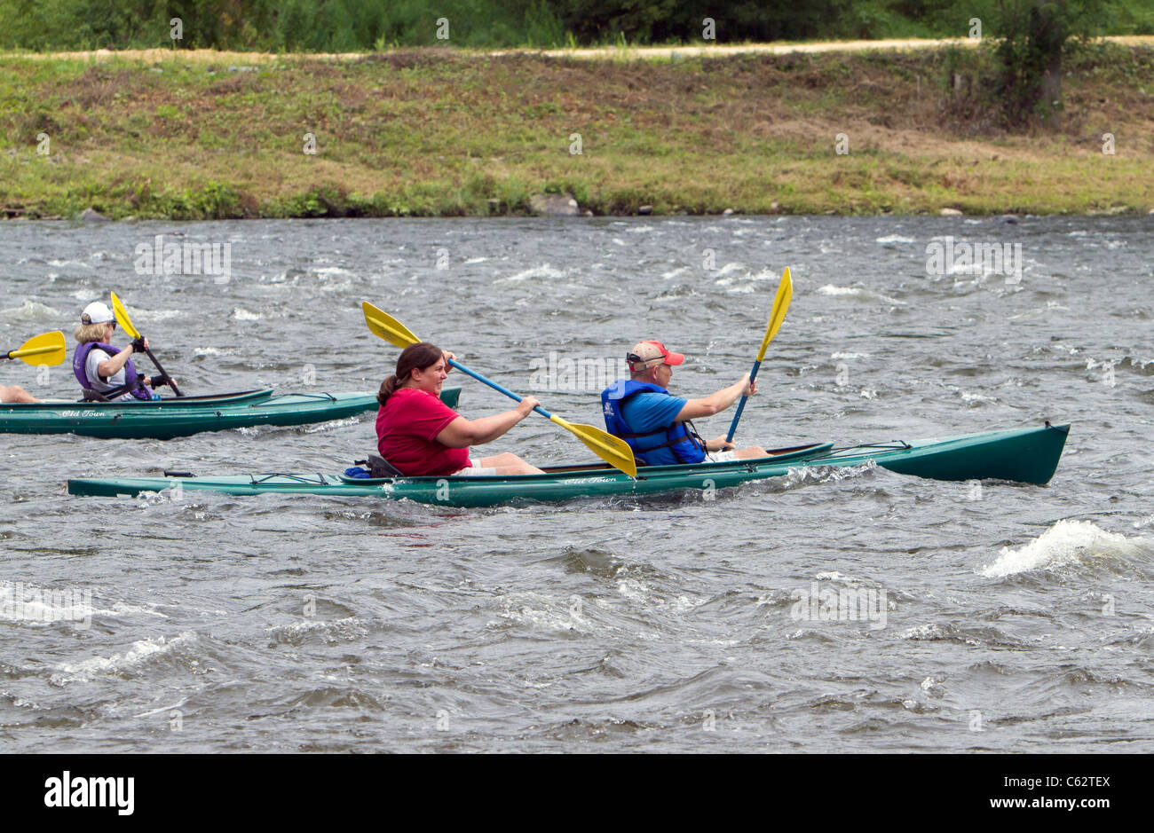 Two couples kayaking in two man kayak in the river rapids Stock Photo ...