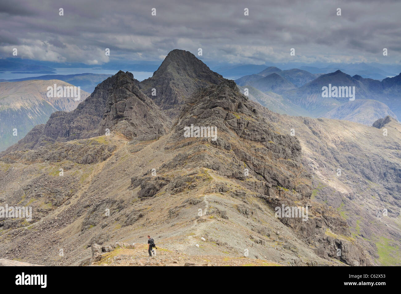 Walker descending Bruach na Frithe towards Sgurr a Fionn Choire, Am ...