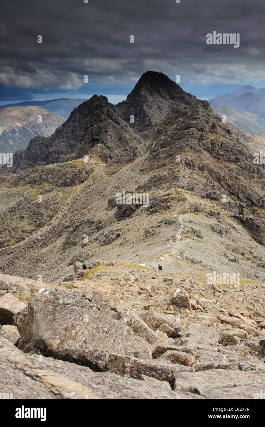 Walker descending Bruach na Frithe towards Sgurr a Fionn Choire, Am ...
