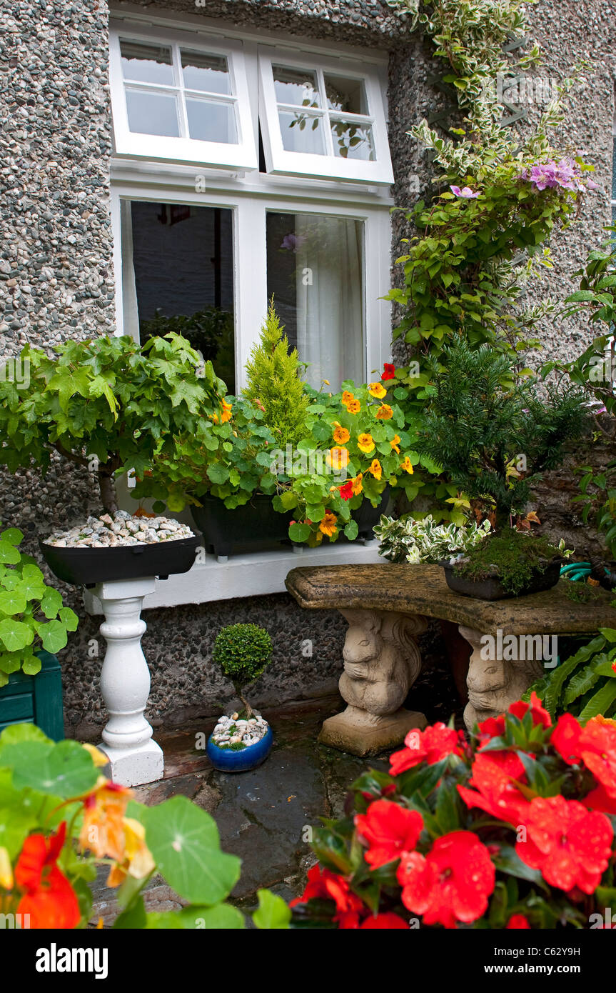 Pretty courtyard garden area outside the window of a traditional house ...