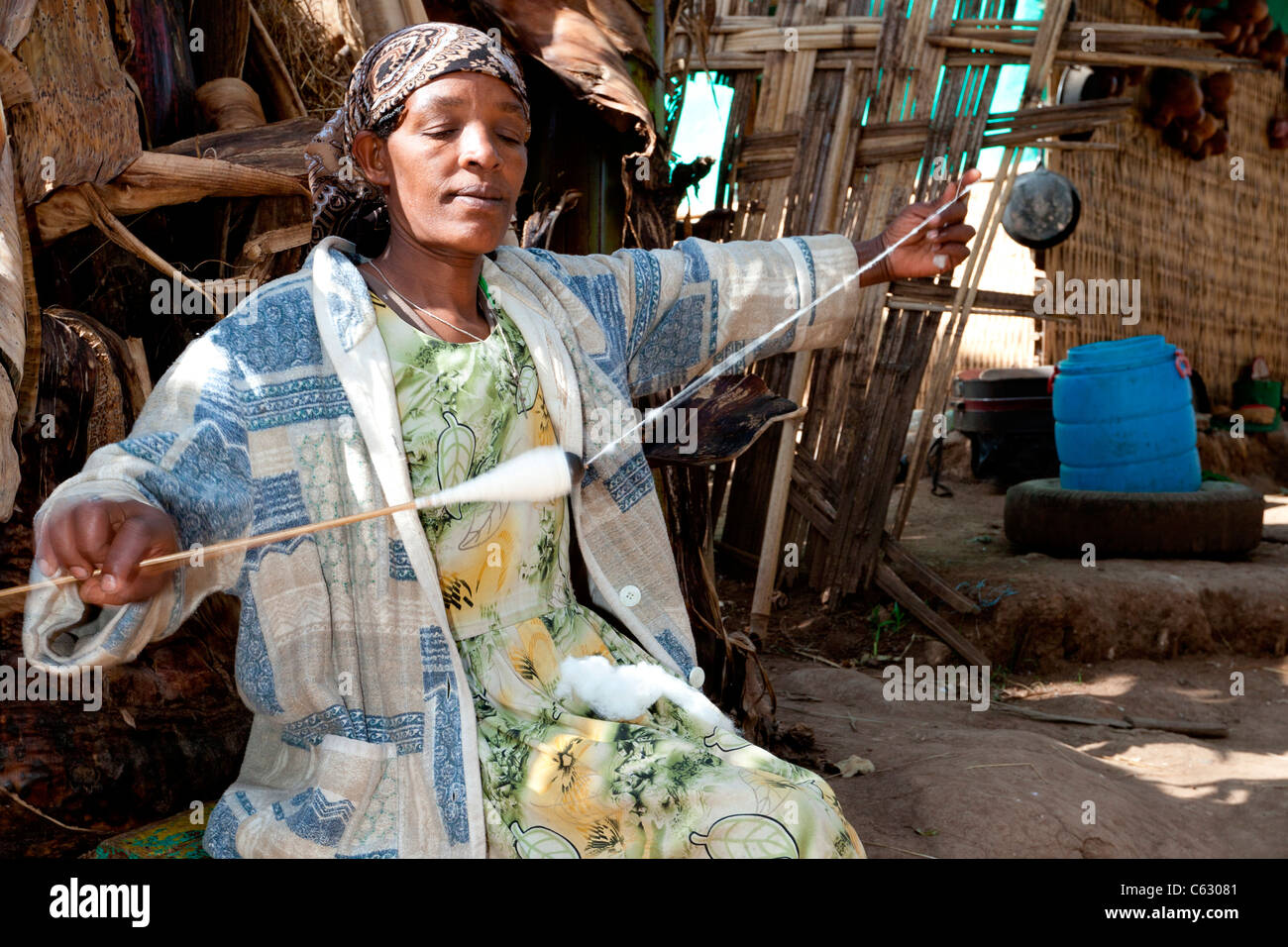 A Dorze tribeswoman spinning cotton at the village of Chencha near Arba ...
