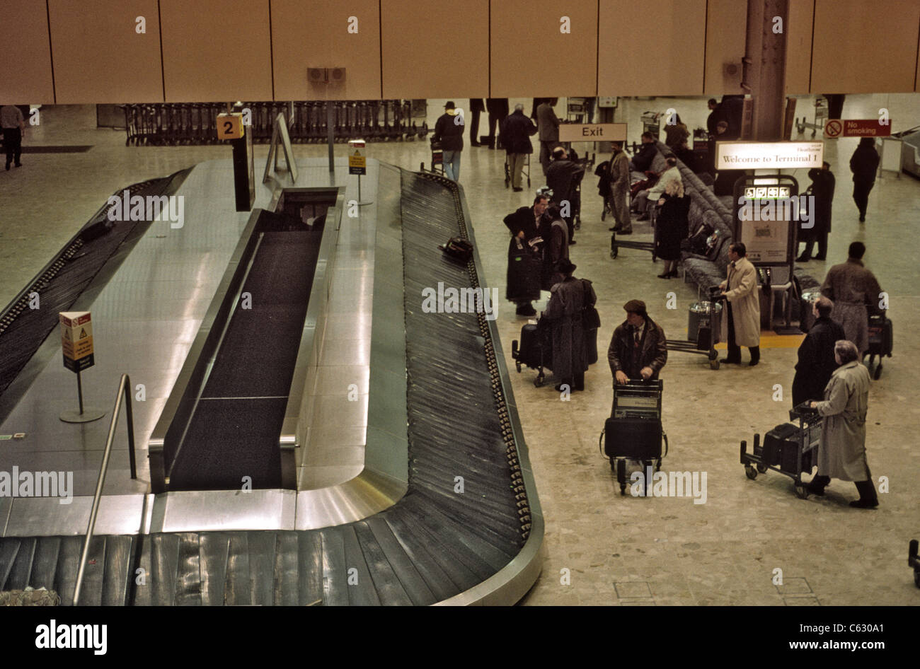 Baggage collection hall in airport with people collecting suitcases ...