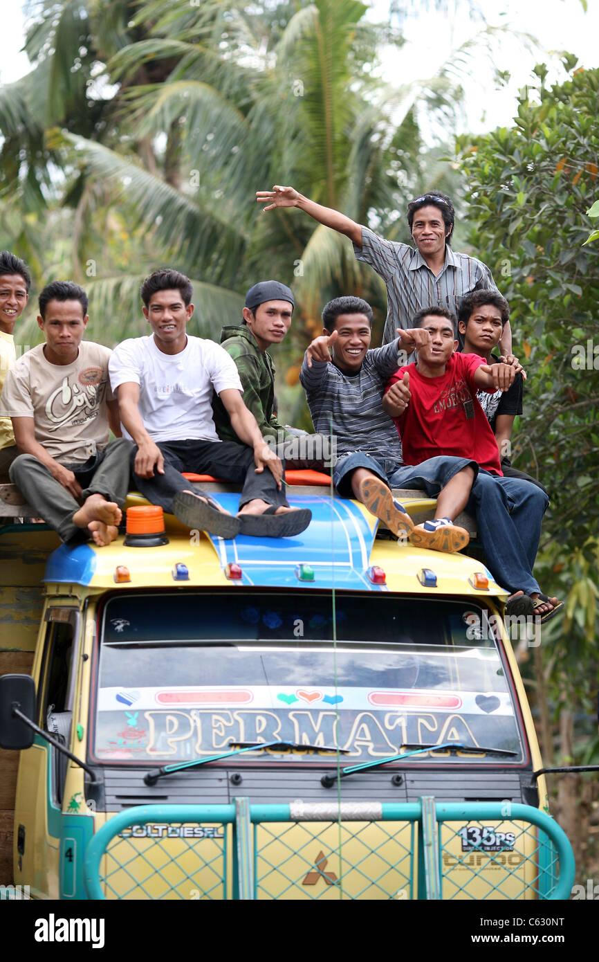 Heavily loaded bus heading towards the beach as people celebrate the ...