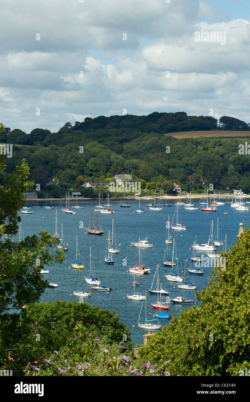 Looking through trees at boats on the river Fal, Falmouth Cornwall UK ...