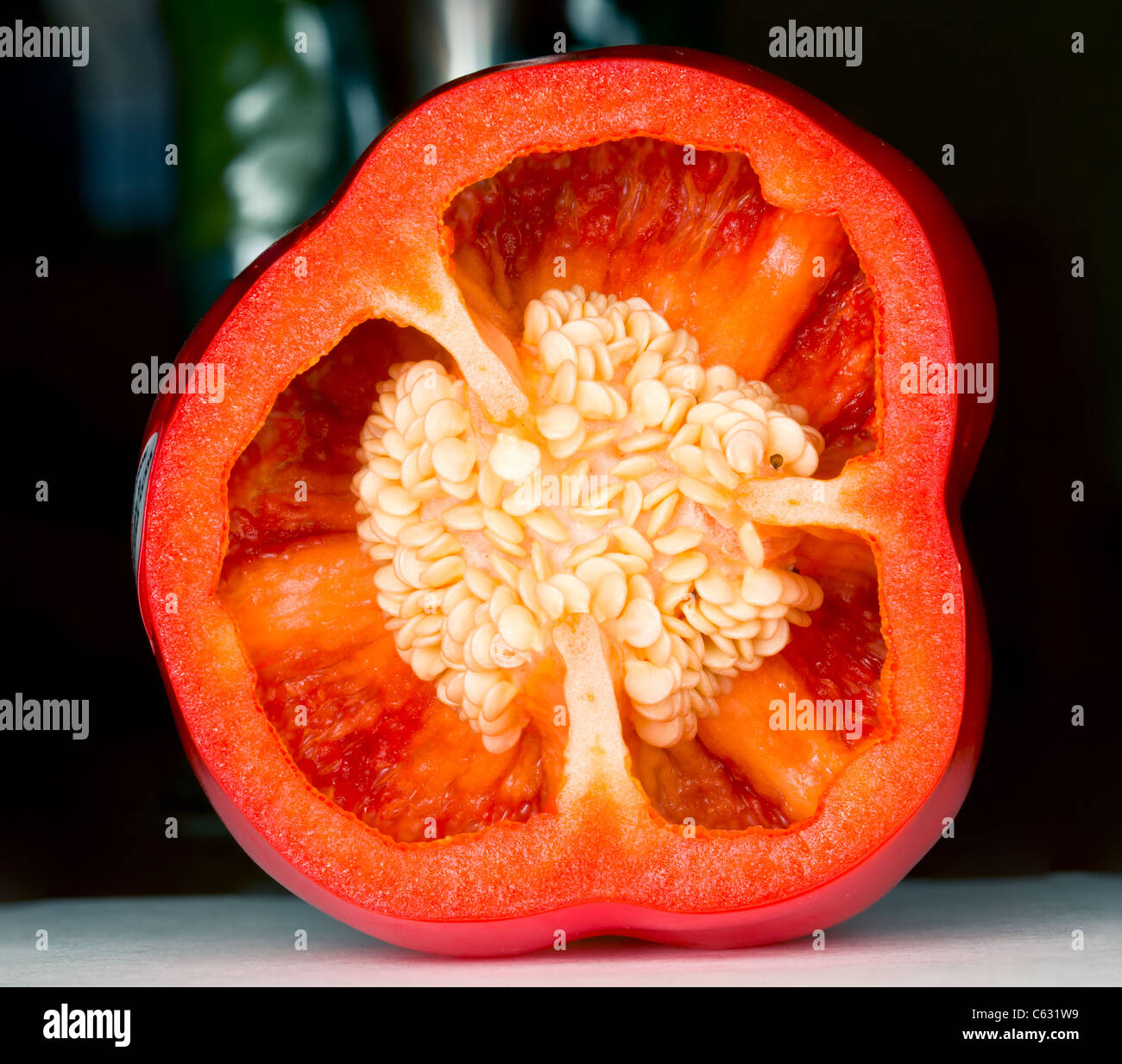 Interior of sliced red pepper in macro shot showing seeds and details ...