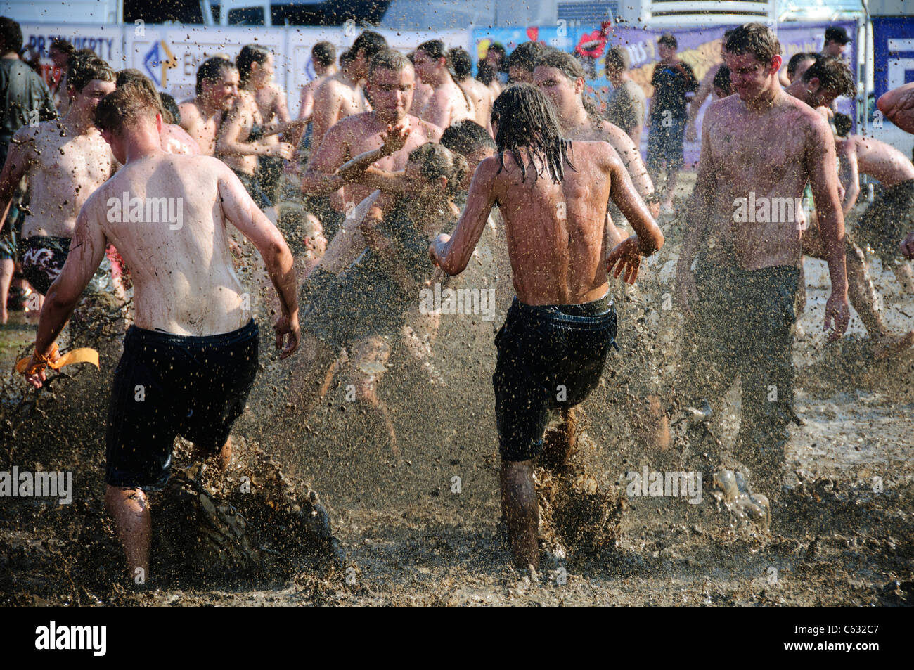 Young people having fun in the mud at the Przystanek Woodstock - Europe ...