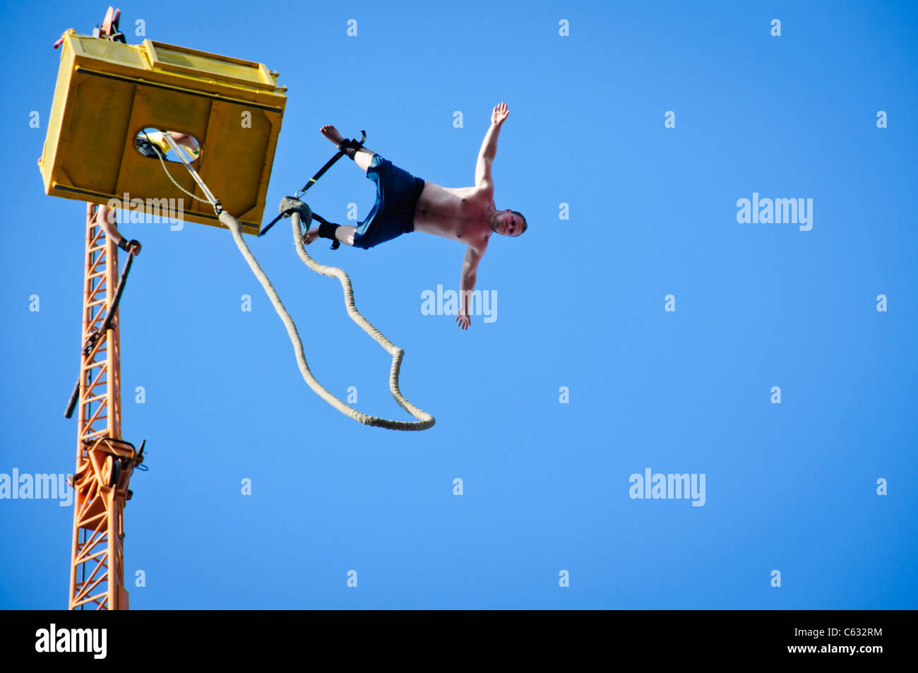 young man Bungee Jumping at Woodstock festival in Kostrzyn, Poland ...