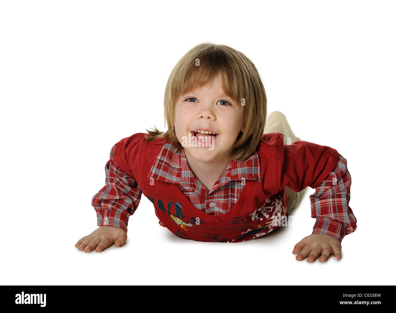 The little boy lays on a floor. It is isolated on a white background ...