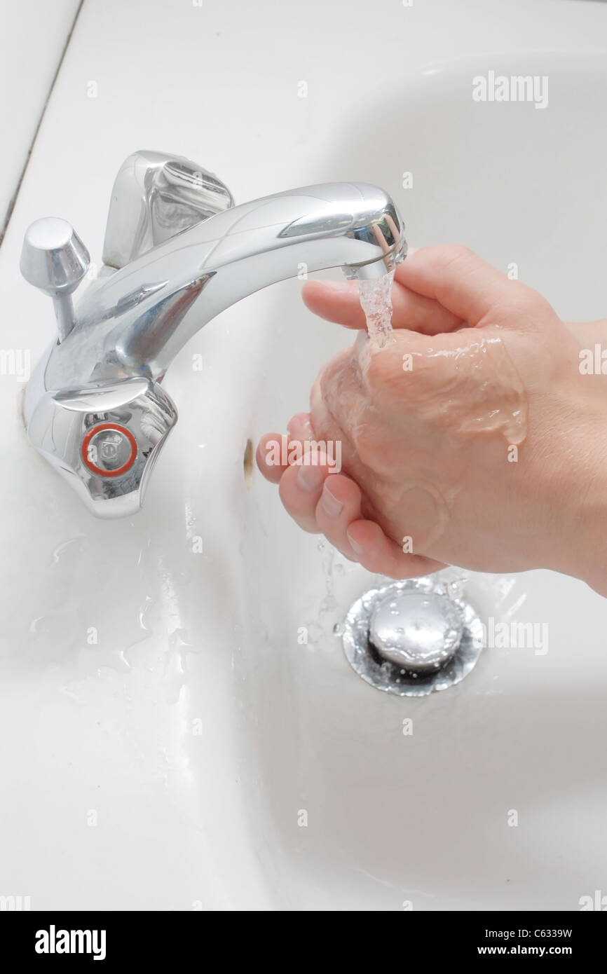 A man washing his hands Stock Photo - Alamy