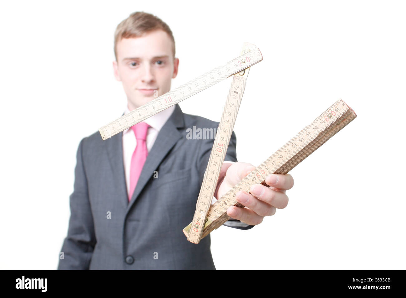 A business man with a folding ruler Stock Photo - Alamy