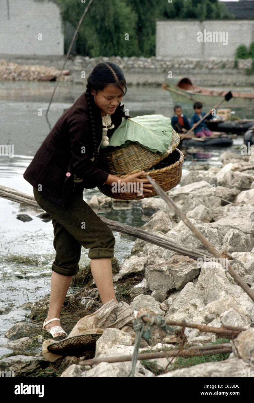 Woman collecting marble rocks from stream in Dali Yunnan China Stock ...