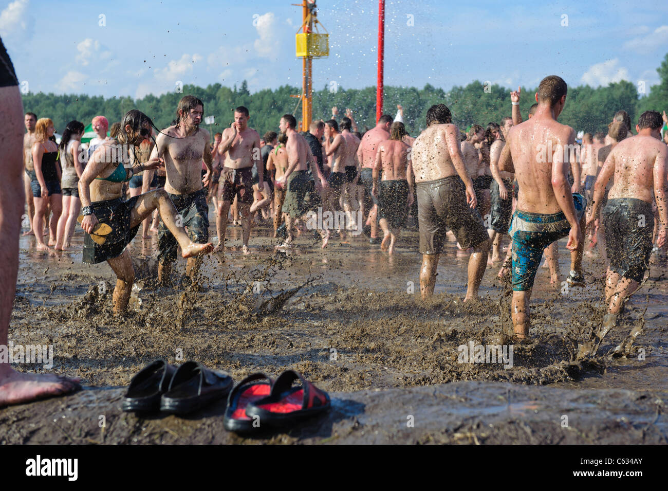 Young people having fun in the mud at the Przystanek Woodstock - Europe ...