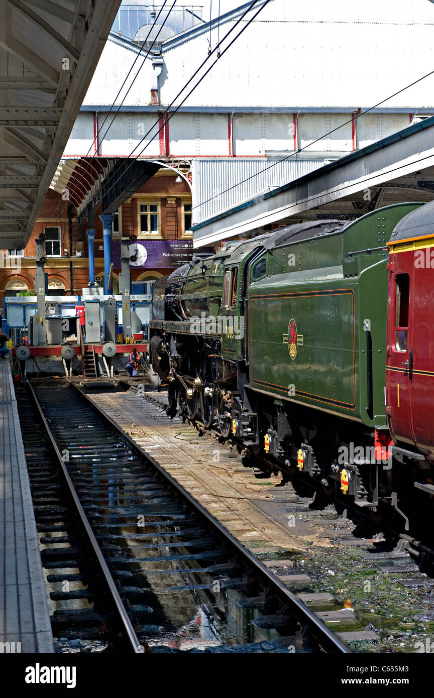 Steam locomotive 70013 'Oliver Cromwell' at a station Terminus Stock ...