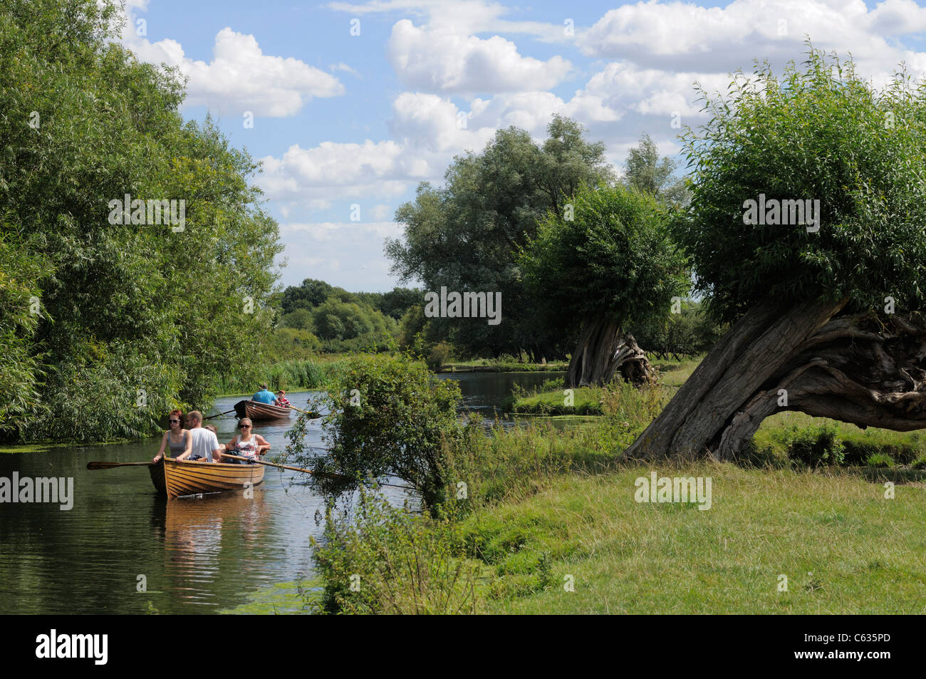 Families enjoying an outing on the River Stour, rowing their boats ...
