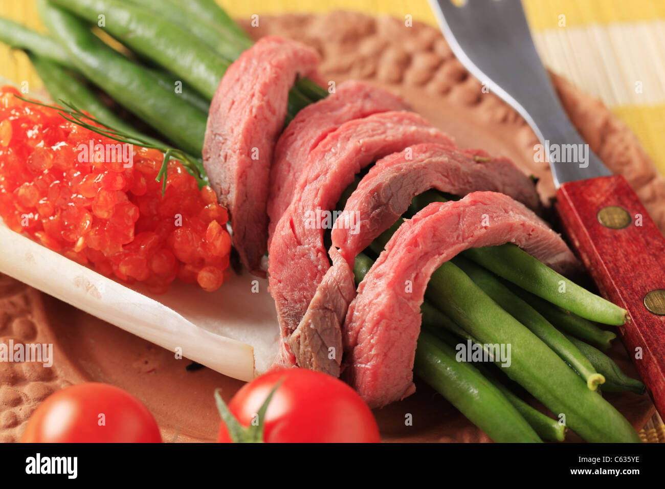 Strips of roast beef and string beans Stock Photo - Alamy