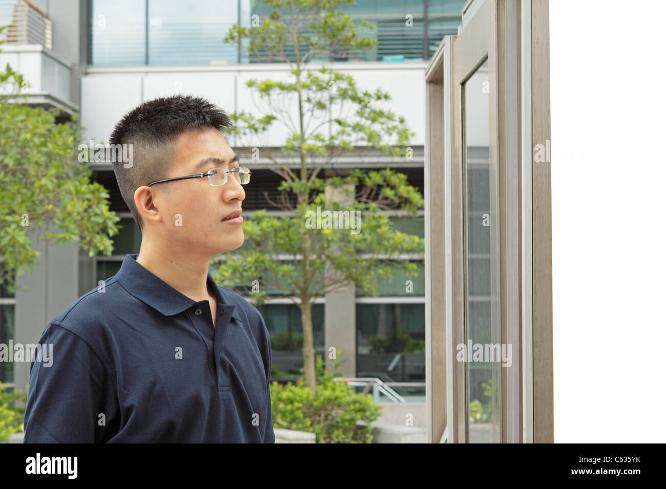 man seeing the advertising board at day Stock Photo - Alamy