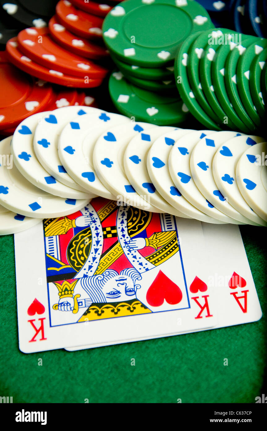 Cassino gambling chips and playing cards on green poker background ...