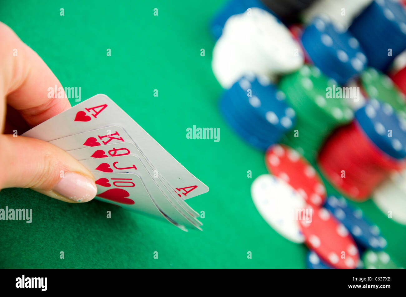 Cassino gambling chips and playing cards on green poker background ...