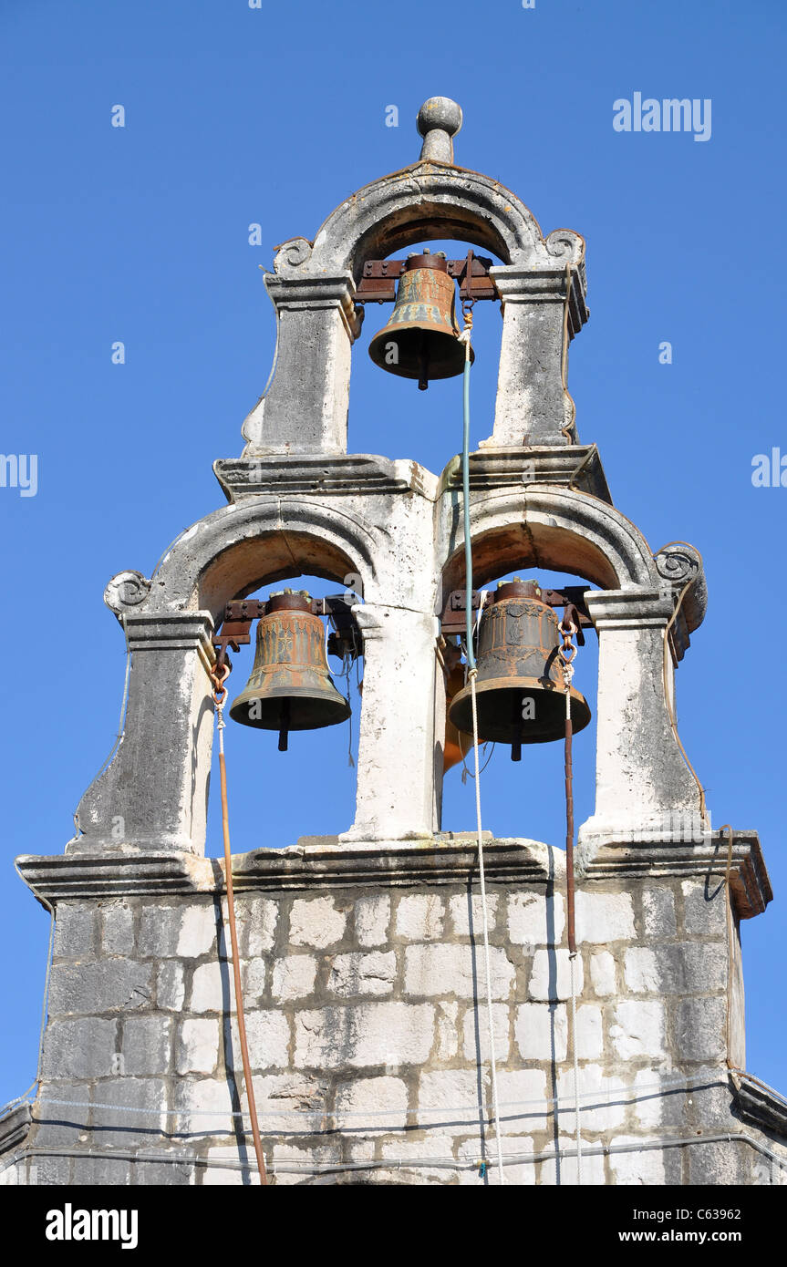Three bells in medieval clock tower with ropes Stock Photo - Alamy