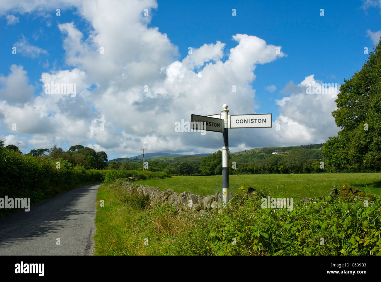 Old-fashioned road sign directing motorists to Coniston, Lake District ...