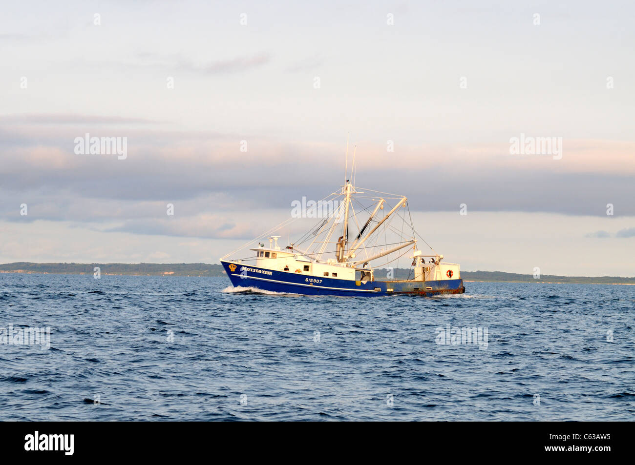 Port side of a blue hulled working fishing boat off the coast of Cape ...