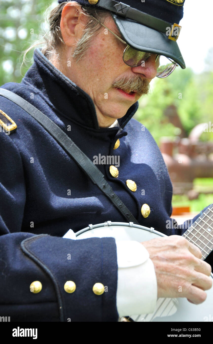Man in Civil War era Union Army uniform playing a banjo at Pioneer Day ...
